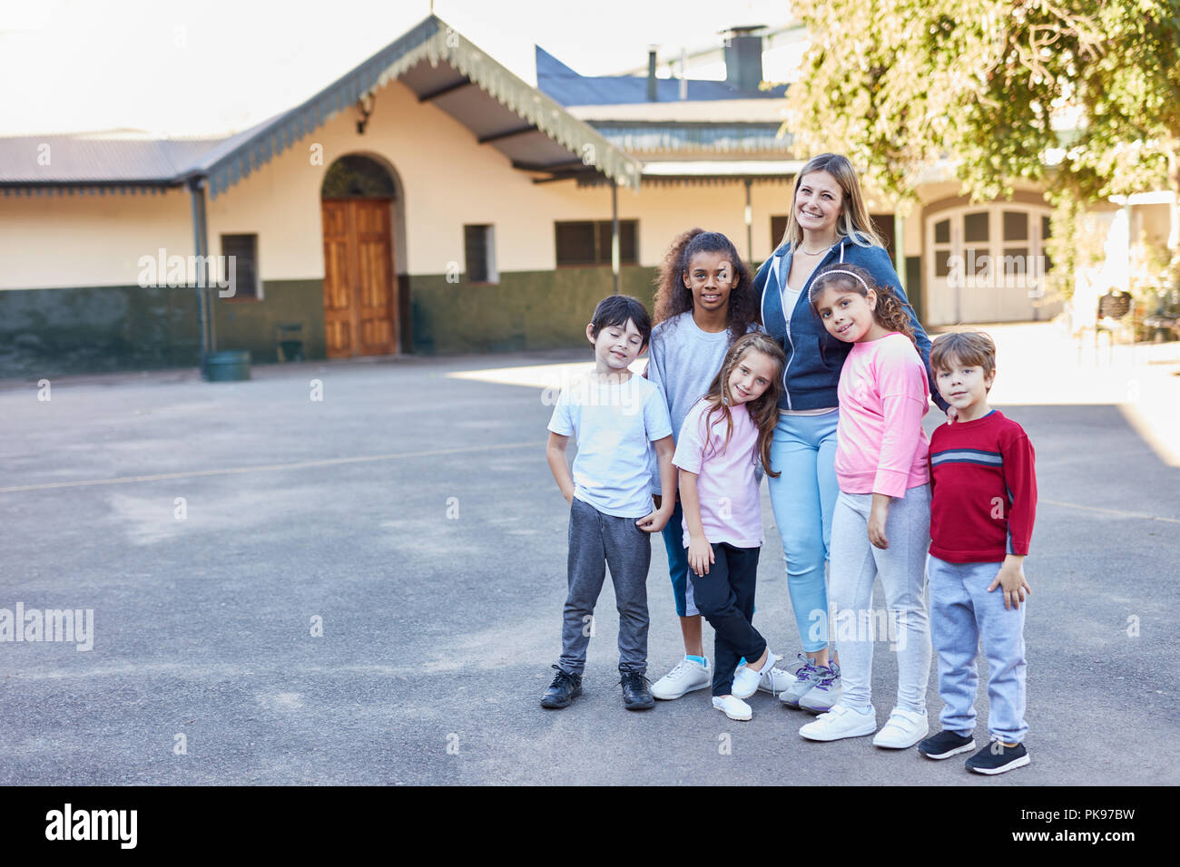 Group of multicultural kids and teachers together in the schoolyard ...