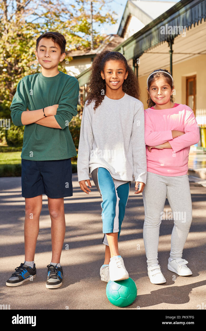 Three students as friends in physical education multicultural school ...