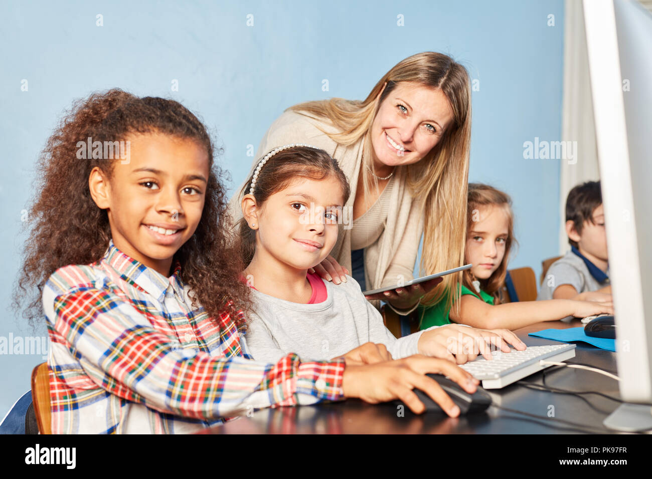 Girls learn at the computer in computer science lessons of elementary ...