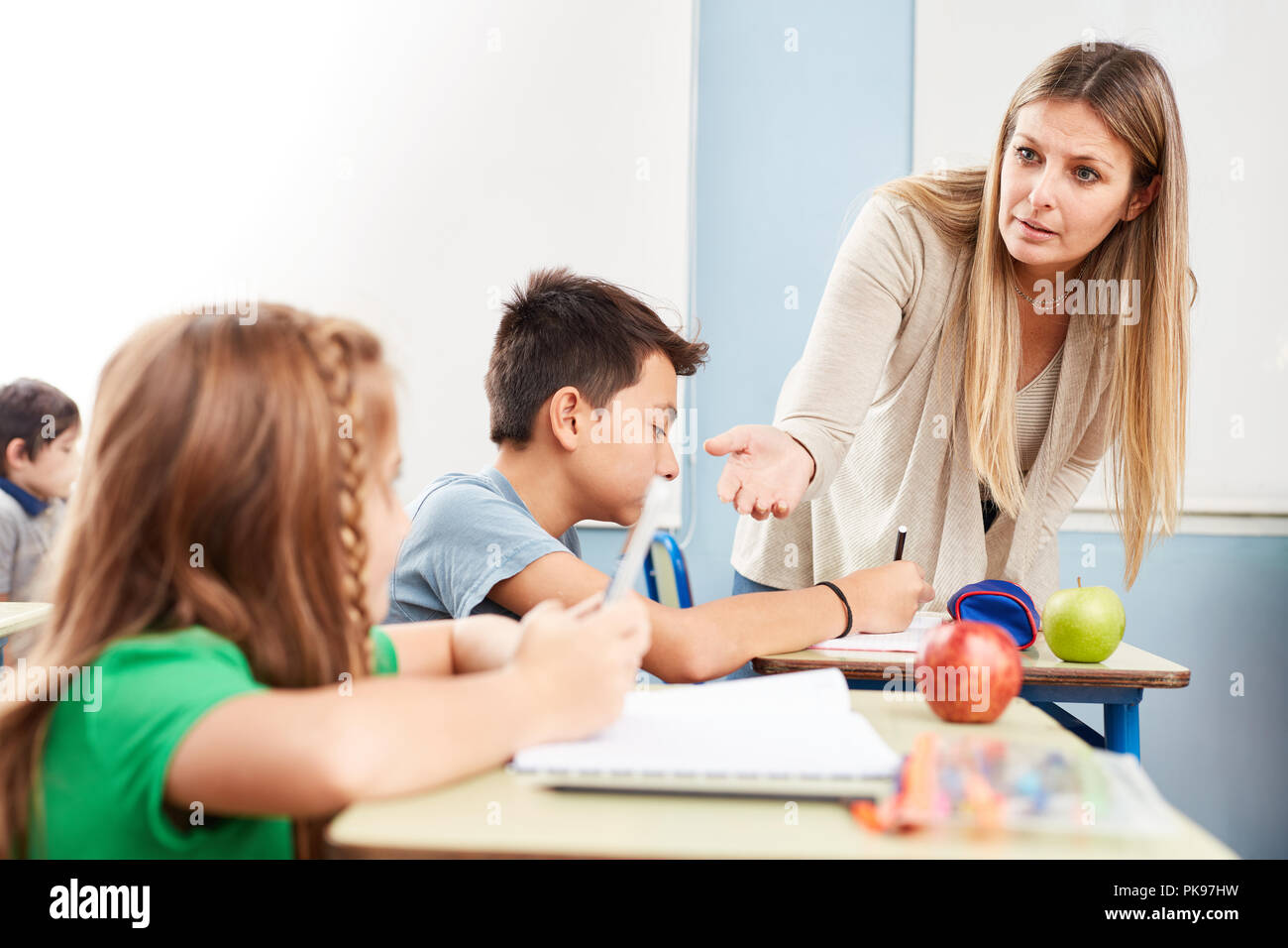 Woman as a teacher forbids a student's mobile phone use in the ...
