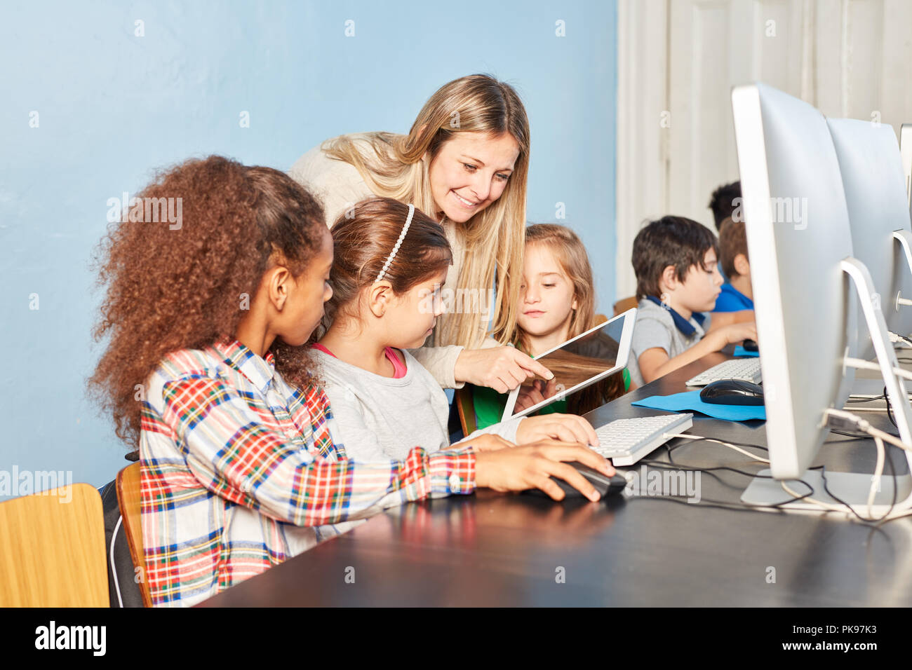 Group student and teacher in computer lessons of elementary school ...