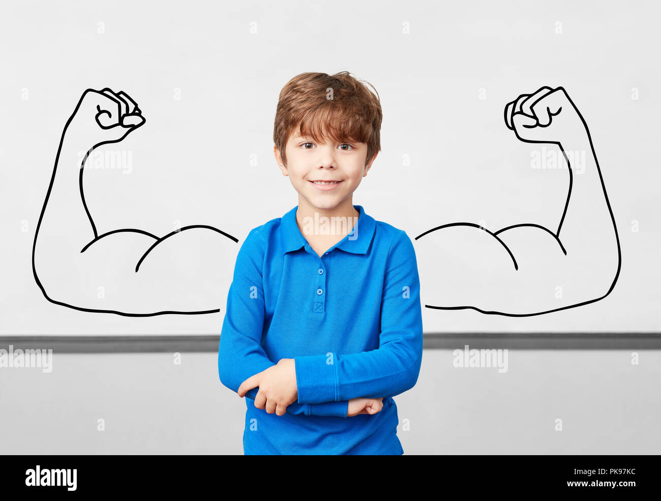 Successful kid in elementary school in front of muscled whiteboard ...