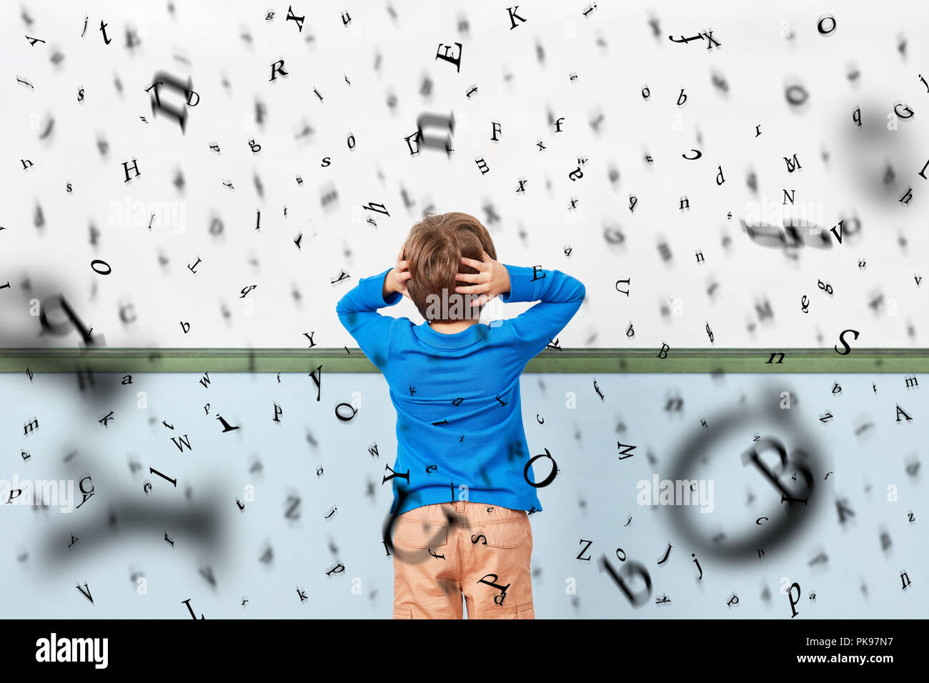 Desperate child with dyslexia in front of a whiteboard with flying ...