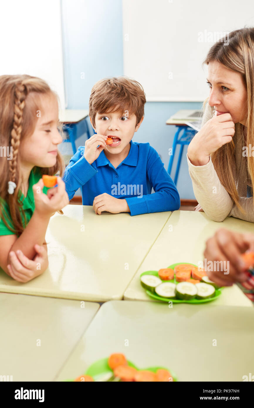 Pupils eat healthy vegetables in the canteen during the break from the ...