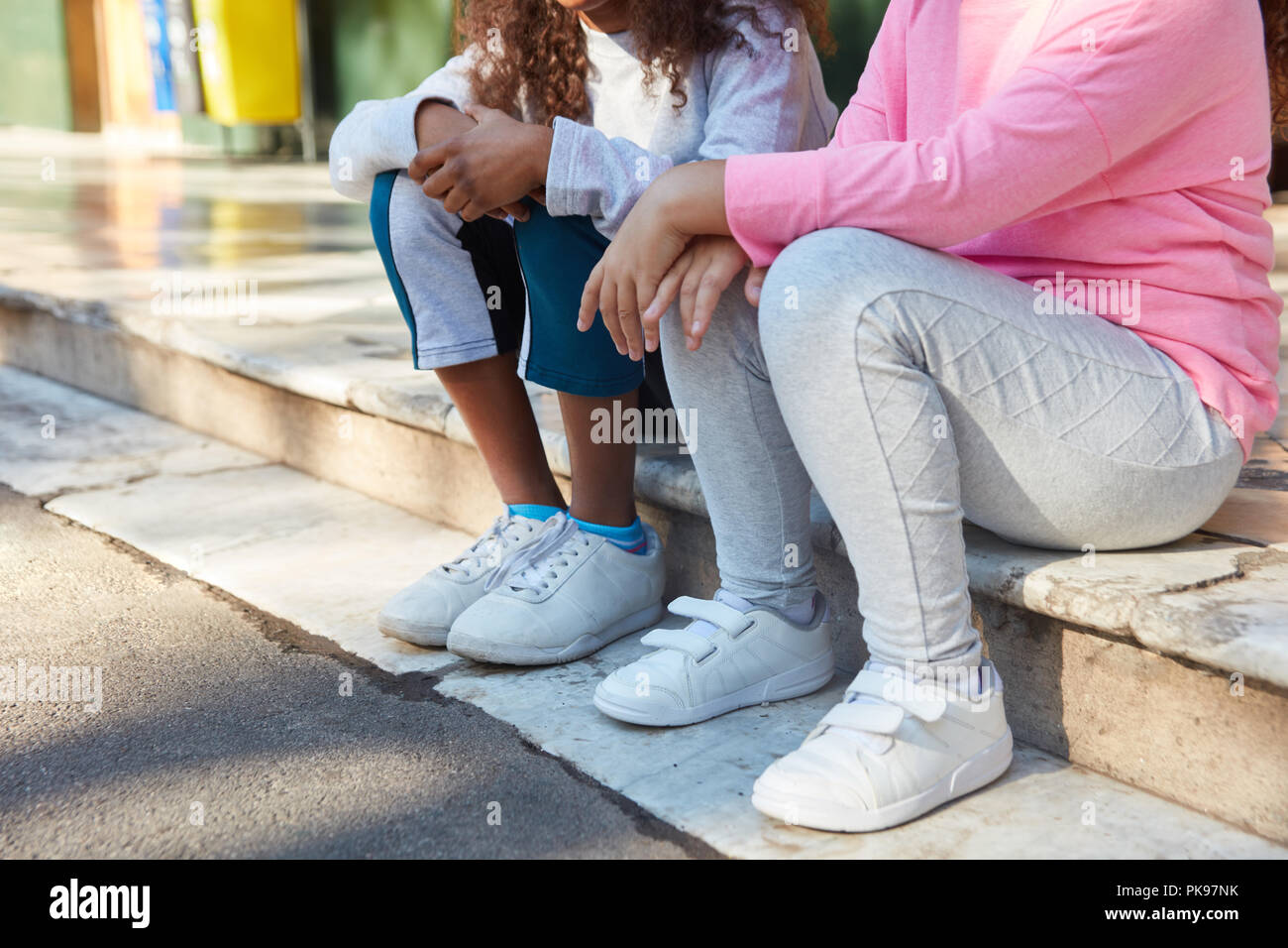Girls sit together in a break at the primary school playground Stock ...
