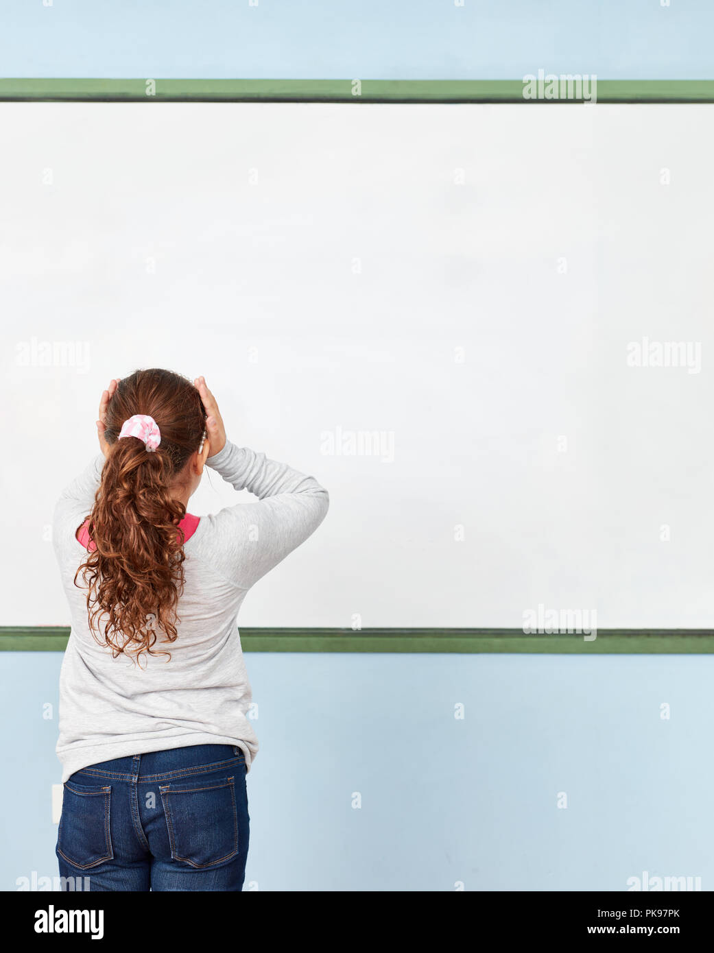 Pupils in a difficult exam at the blackboard of elementary school while ...