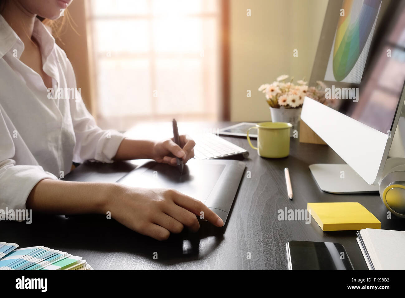 Artist drawing something on graphic tablet with creative desk at the ...