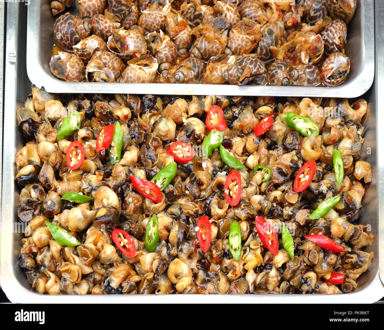 Fried sea snails with red and green hot chili Stock Photo - Alamy