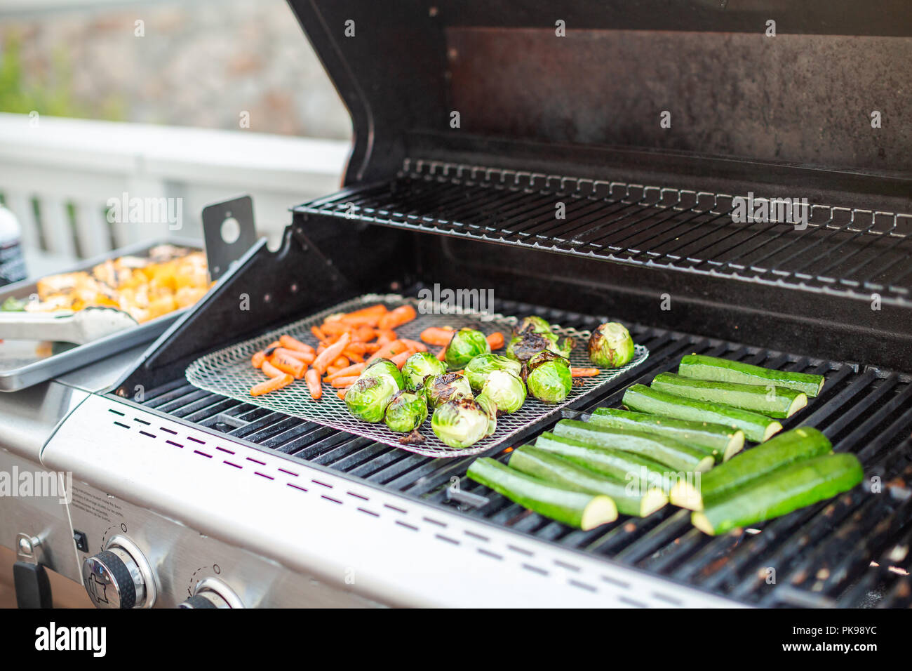 Cooking healthy dinner on outdoor gas grill Stock Photo - Alamy