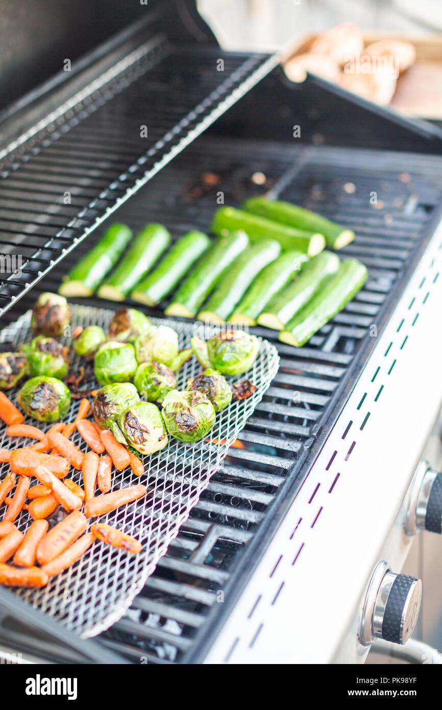 Cooking healthy dinner on outdoor gas grill Stock Photo - Alamy