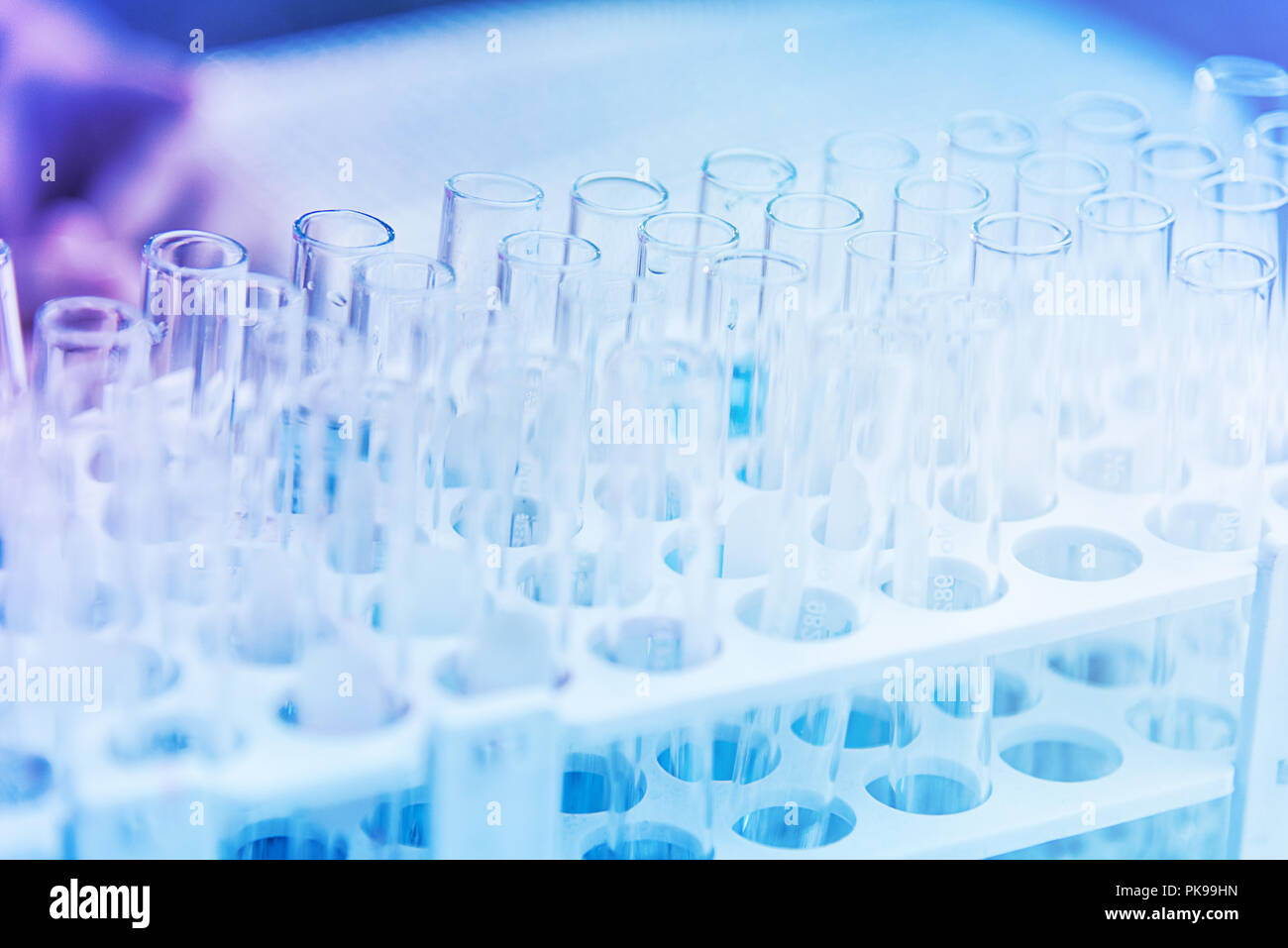 Lab science research glass items adding drop to one of several test ...