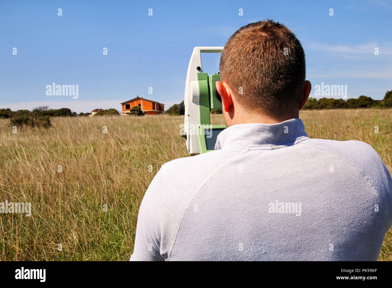 Man using of total station. Guy surveyor at work. Survey Instrument ...
