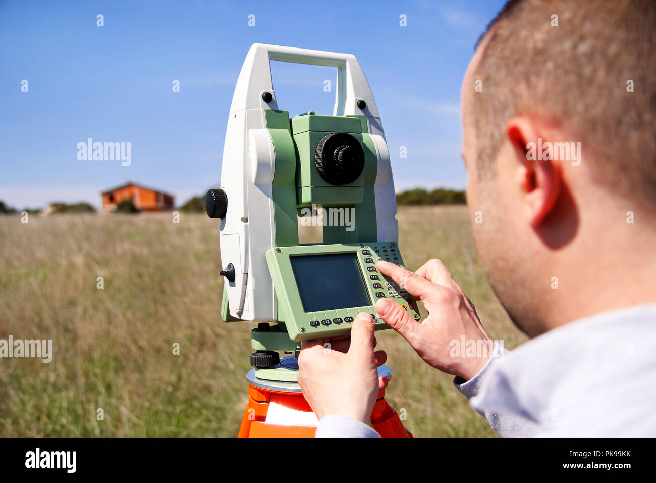 Man using of total station. Guy surveyor at work. Survey Instrument ...