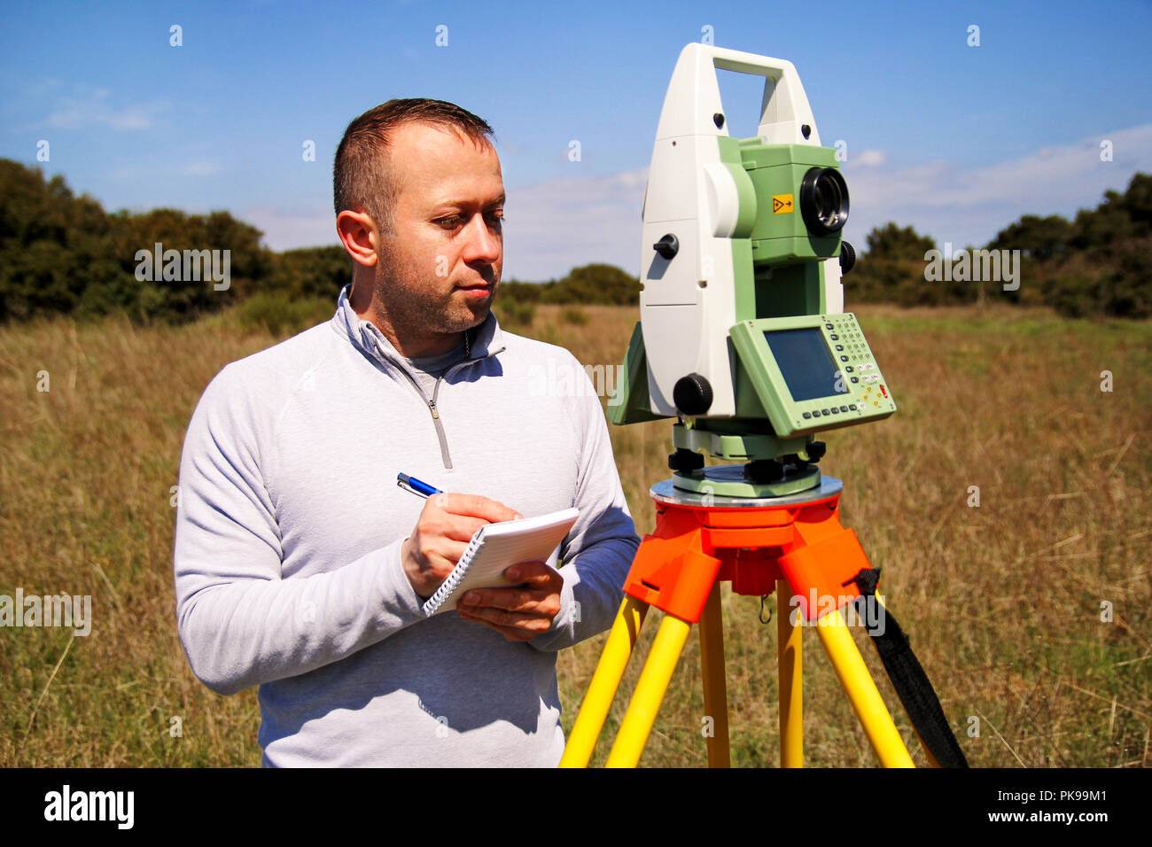 Man using of total station. Guy surveyor at work. Survey Instrument ...