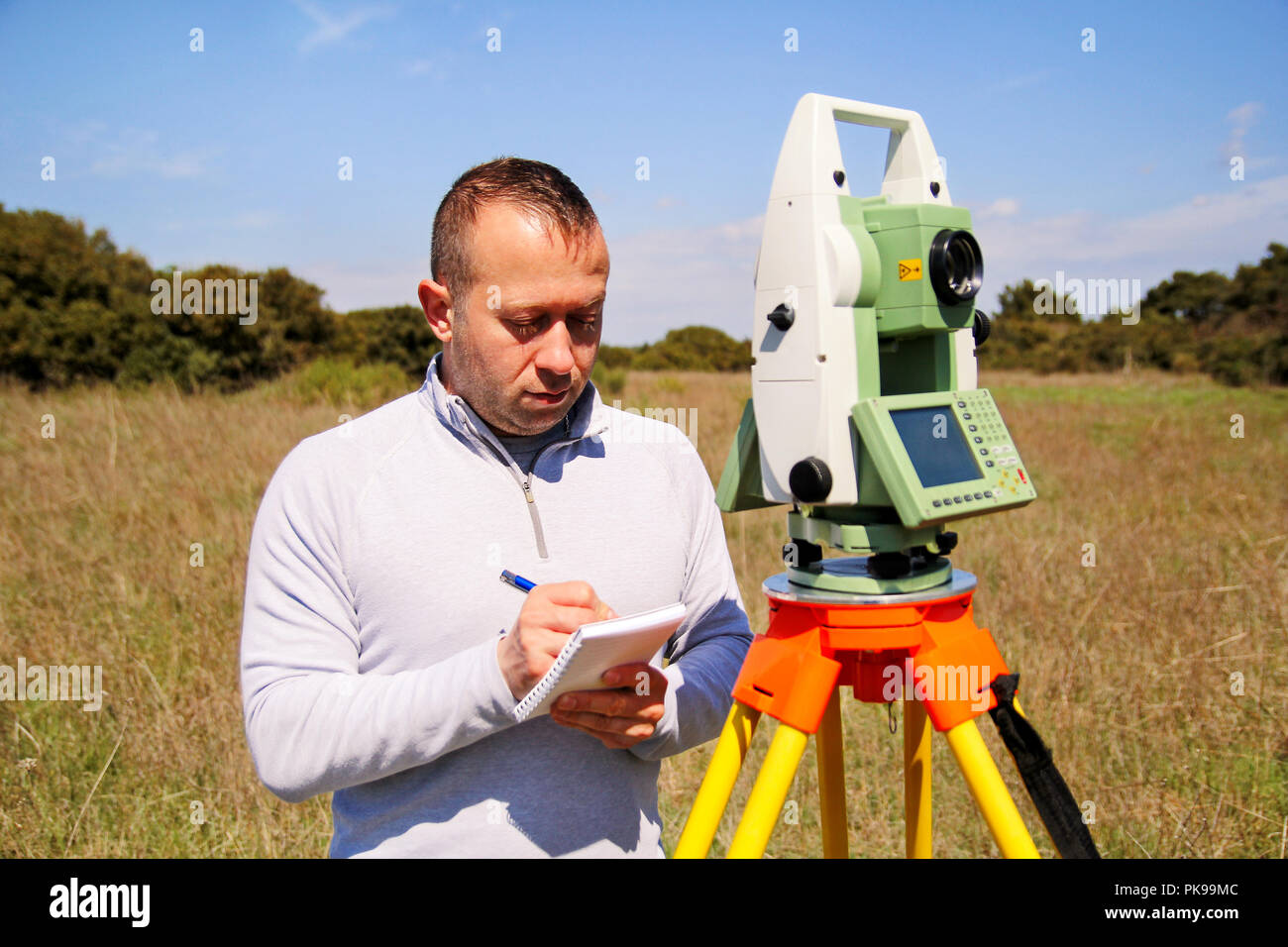 Man surveyor at work and using of total station. Survey Instrument ...