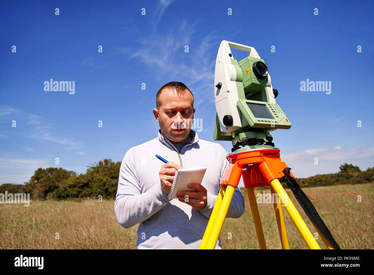 Man surveyor at work and using of total station. Survey Instrument ...