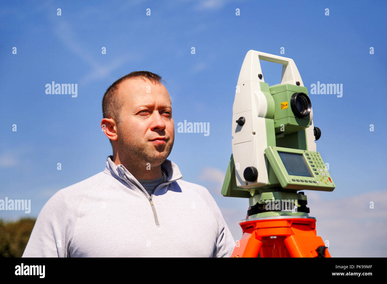 Man surveyor at work and using of total station. Survey Instrument ...