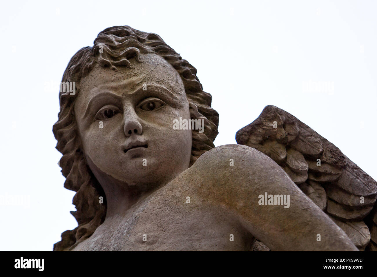 Children angel statue in city cemetery isolated with white background ...