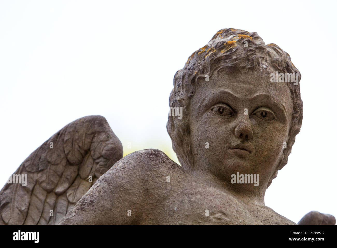 Children angel statue in city cemetery isolated with white background ...