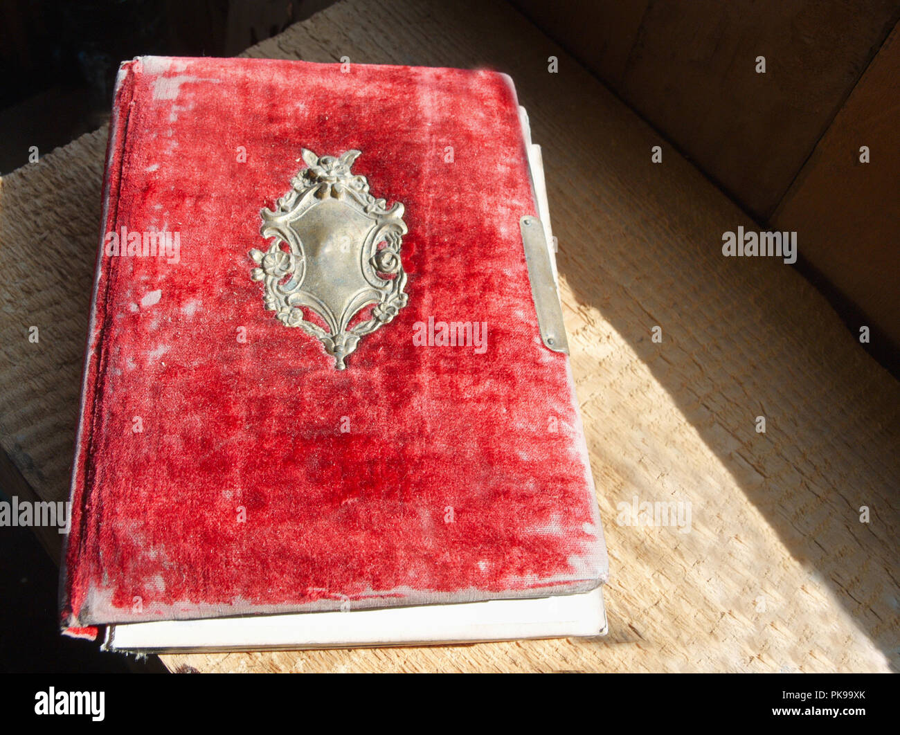 Old book with red velvet cover and bronze decoration Stock Photo - Alamy