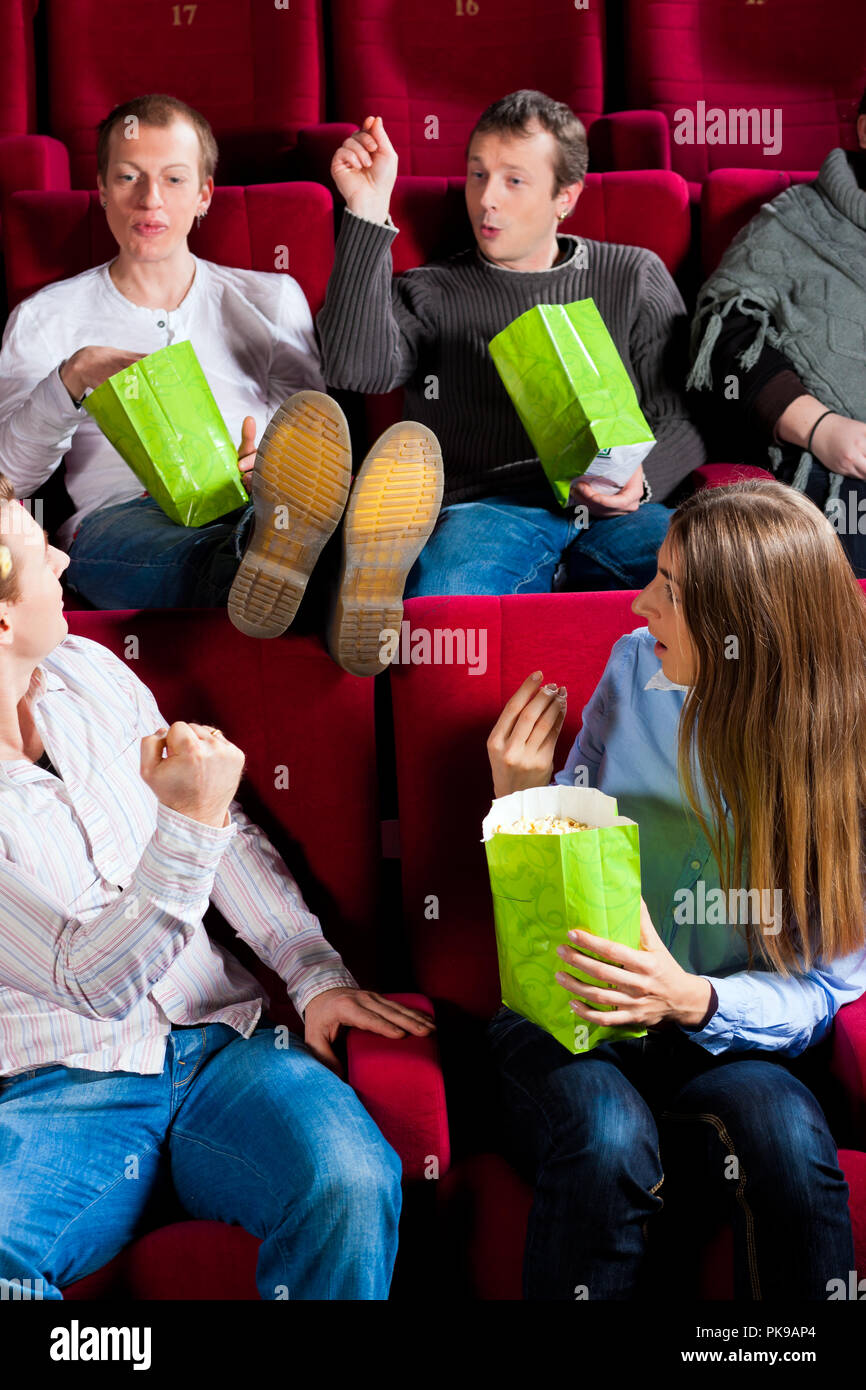 People eating popcorn in theatre Stock Photo - Alamy