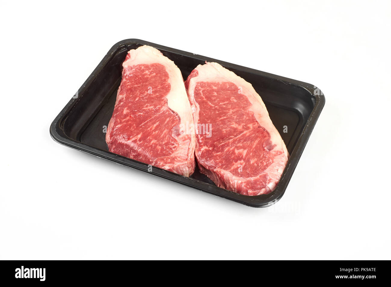 Raw steak in package. Isolated on white background Stock Photo - Alamy