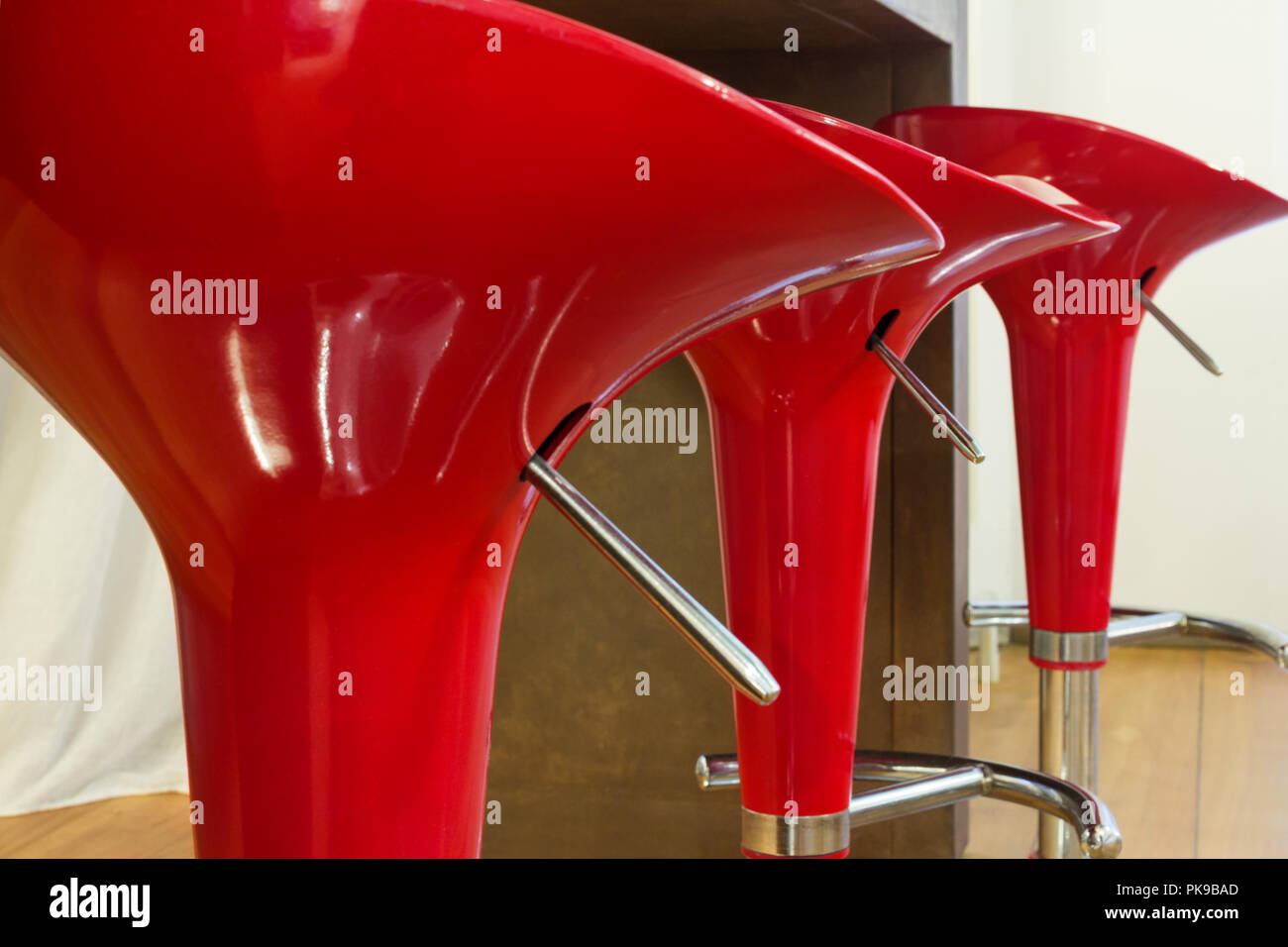 Interior of modern kitchen, detail of red stools Stock Photo - Alamy