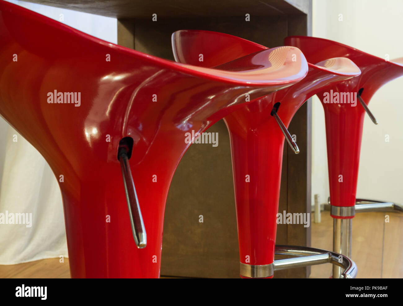 Interior of modern kitchen, detail of red stools Stock Photo - Alamy