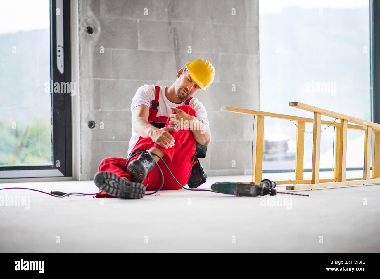 An accident of a man worker at the construction site Stock Photo - Alamy