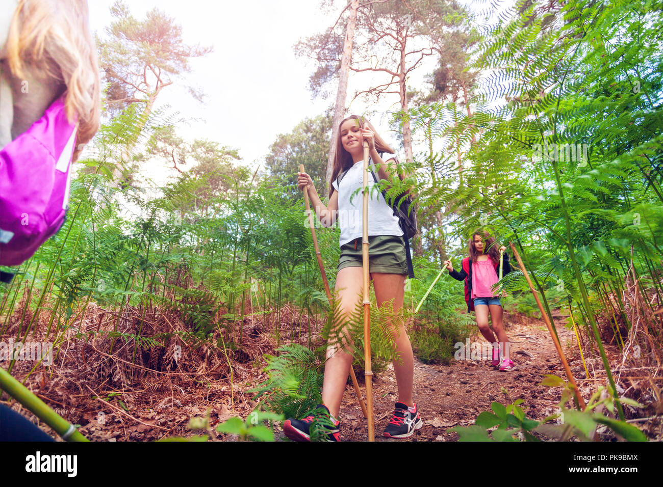 Portrait of a girl walking in group on hike trail Stock Photo - Alamy