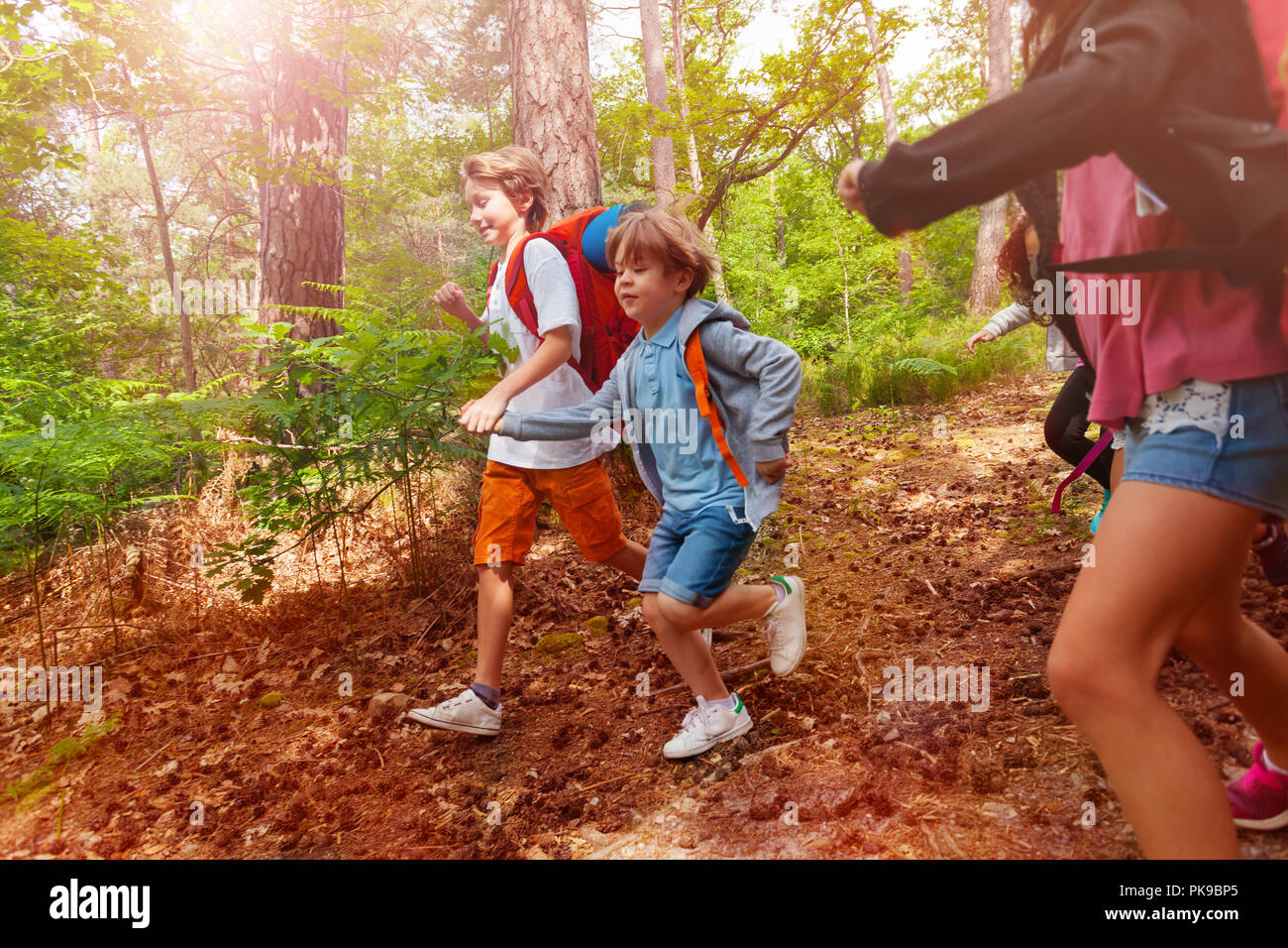 Two boys running in forest hi-res stock photography and images - Alamy