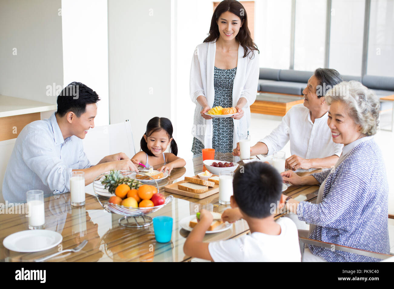 Happy family having breakfast Stock Photo - Alamy