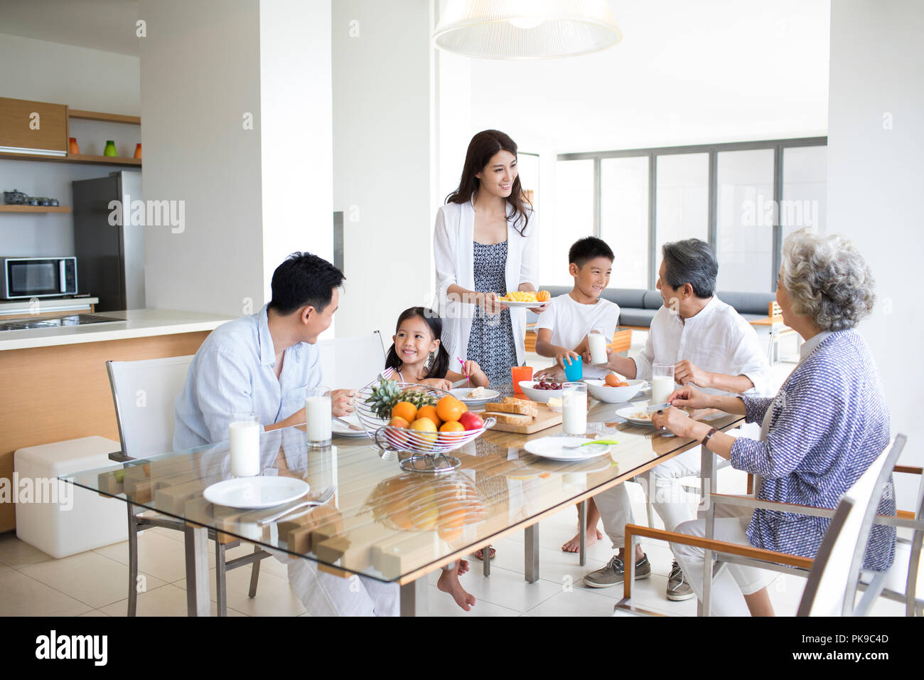 Happy family having breakfast Stock Photo - Alamy
