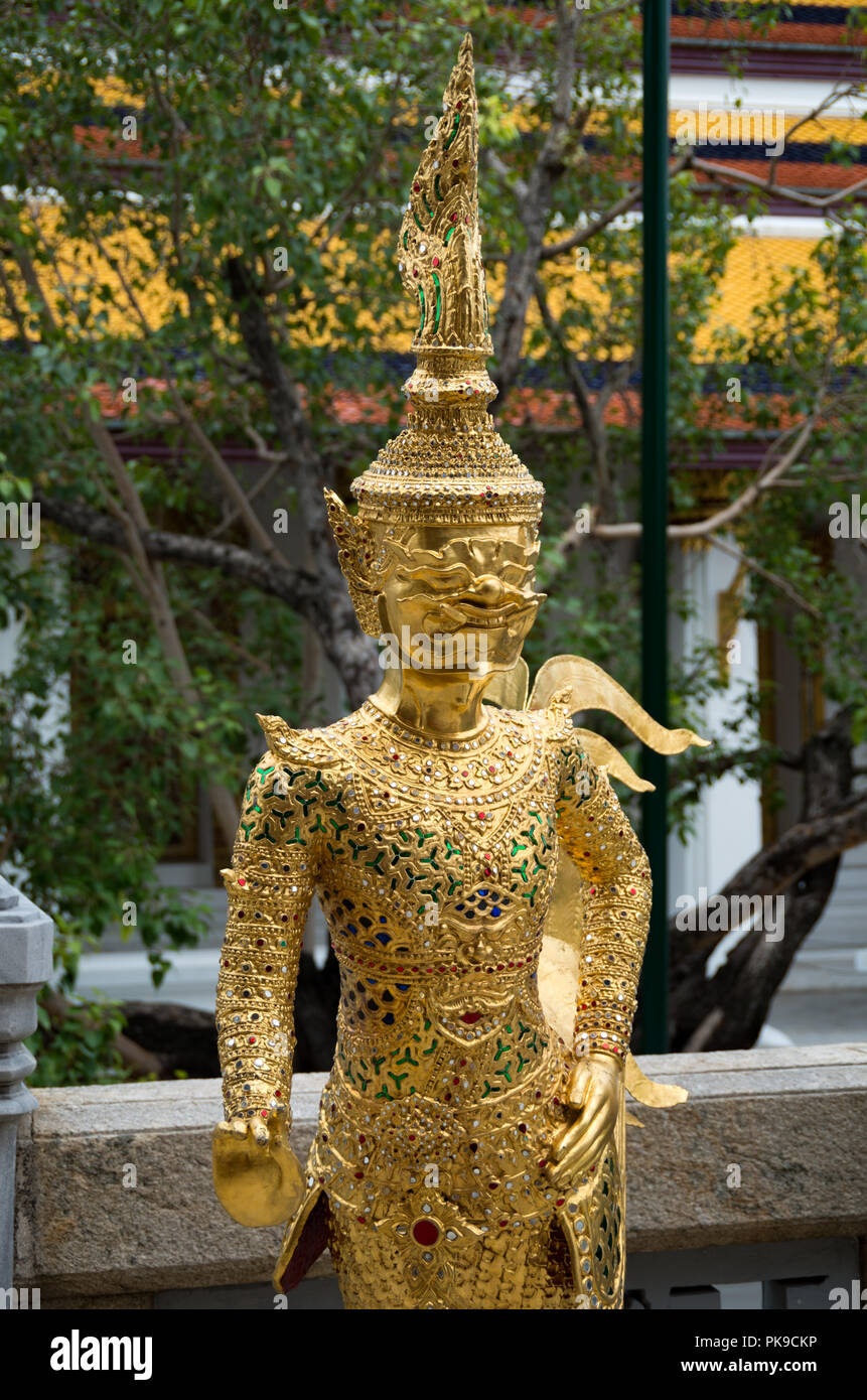 Golden, mythical statue with gemstones in the Grand Palace of Bangkok ...