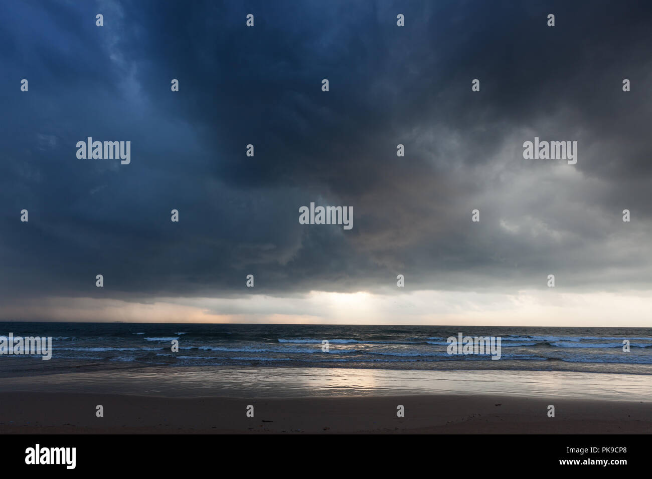Gathering storm on beach Stock Photo - Alamy