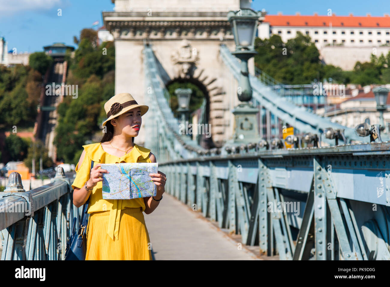 Female tourist with a map exploring Budapest and the chain bridge Stock ...