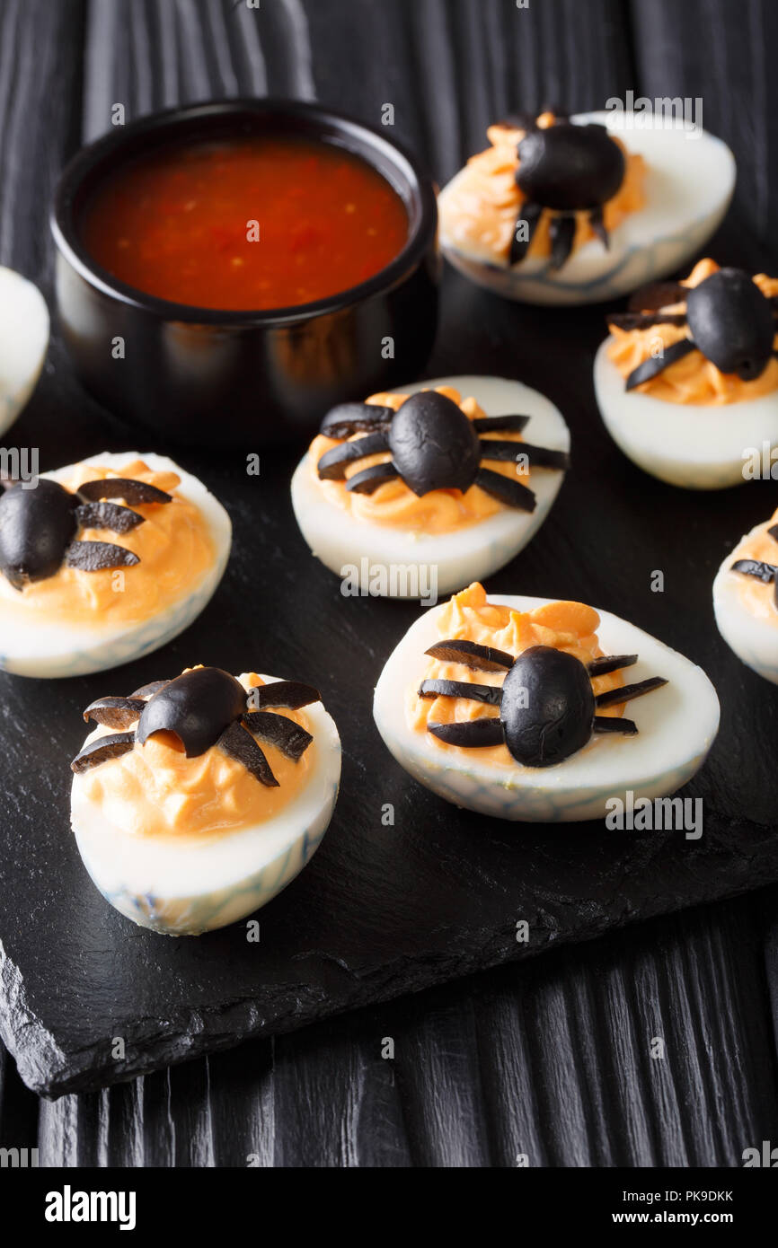 Halloween menu deviled eggs stuffed with mustard and decorated with ...