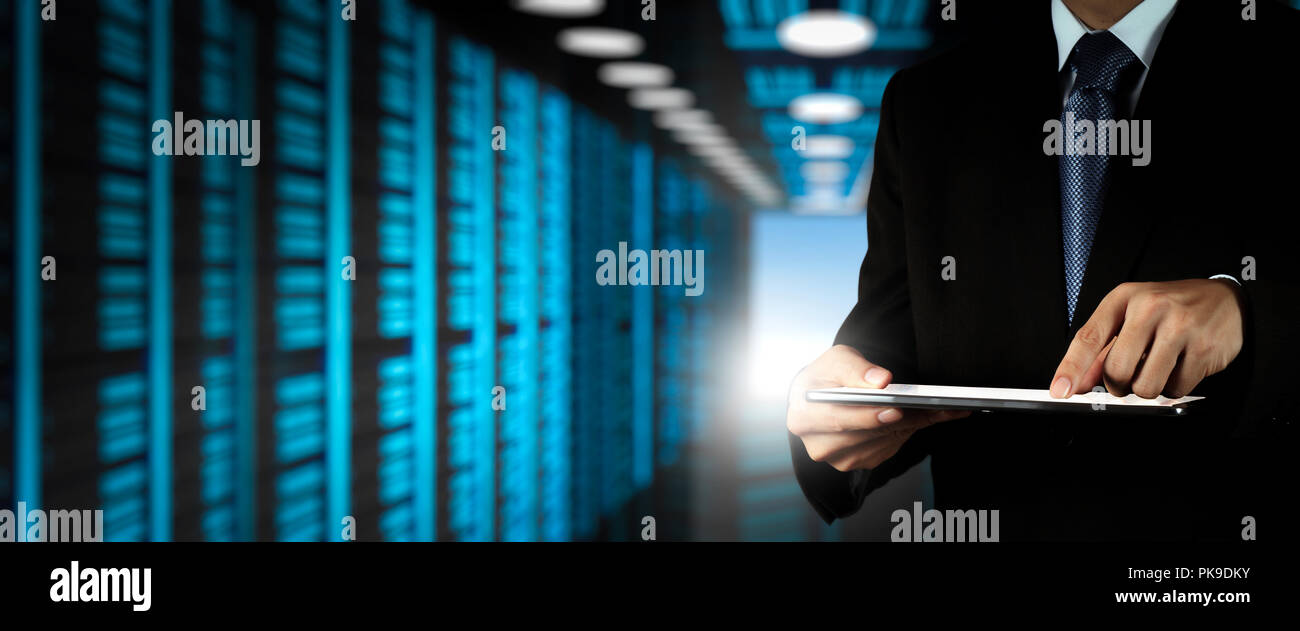 Businessman working with VR wide blank screen computer on server room ...