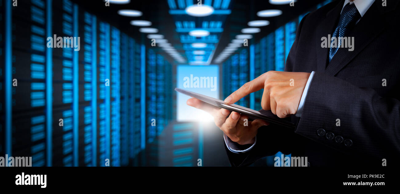 Businessman working with VR wide blank screen computer on server room ...