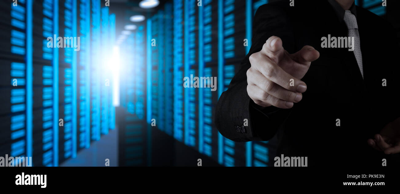 Businessman working with VR wide blank screen computer on server room ...