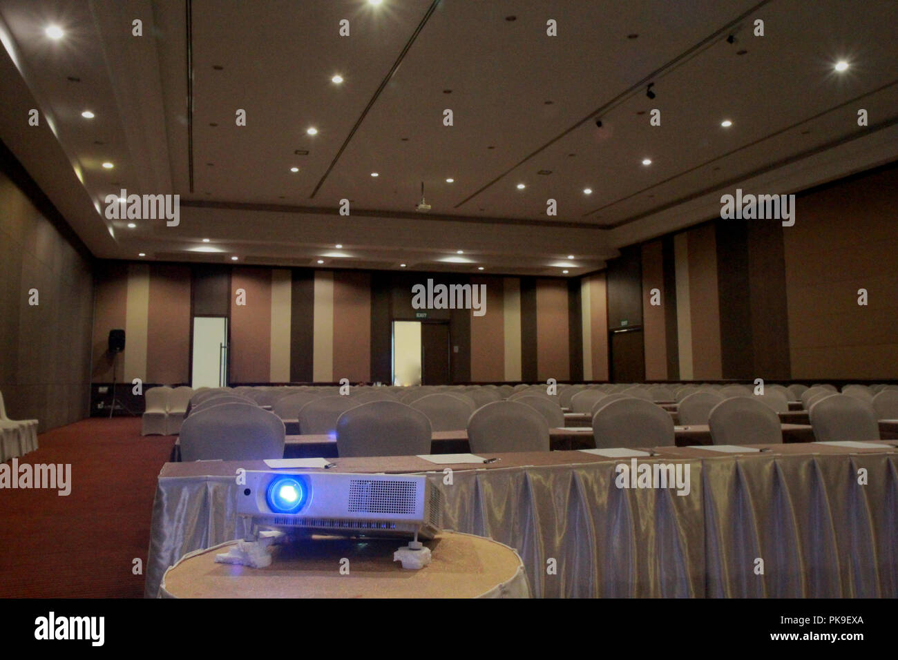 The projector is placed on a table covered with a white cloth placed in ...