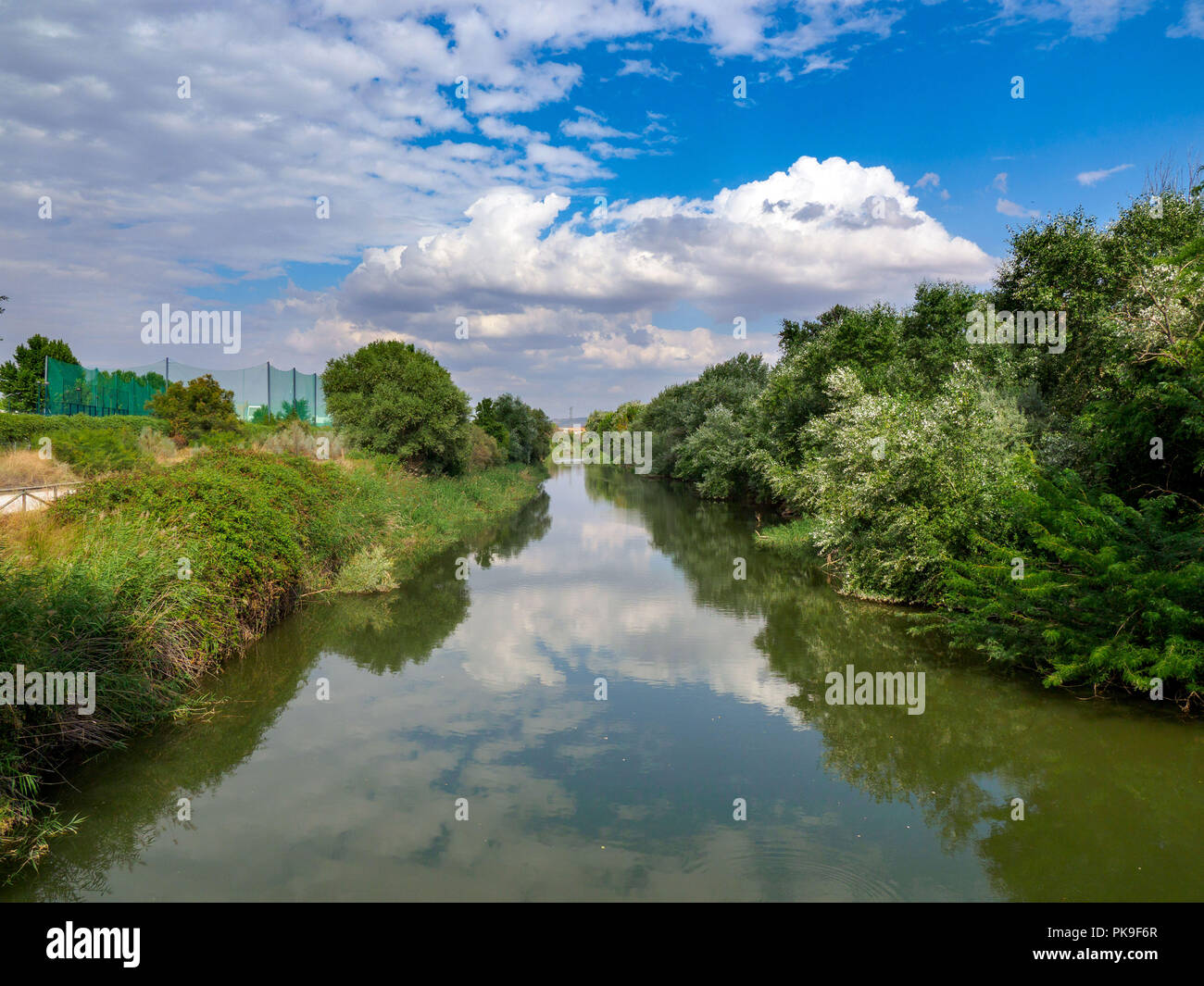 Henares river on its way through the city of Alcala de Henares in Spain ...
