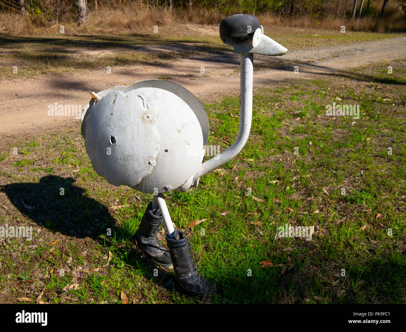 metalwork in the form of a humorous bird at the roadside, between ...