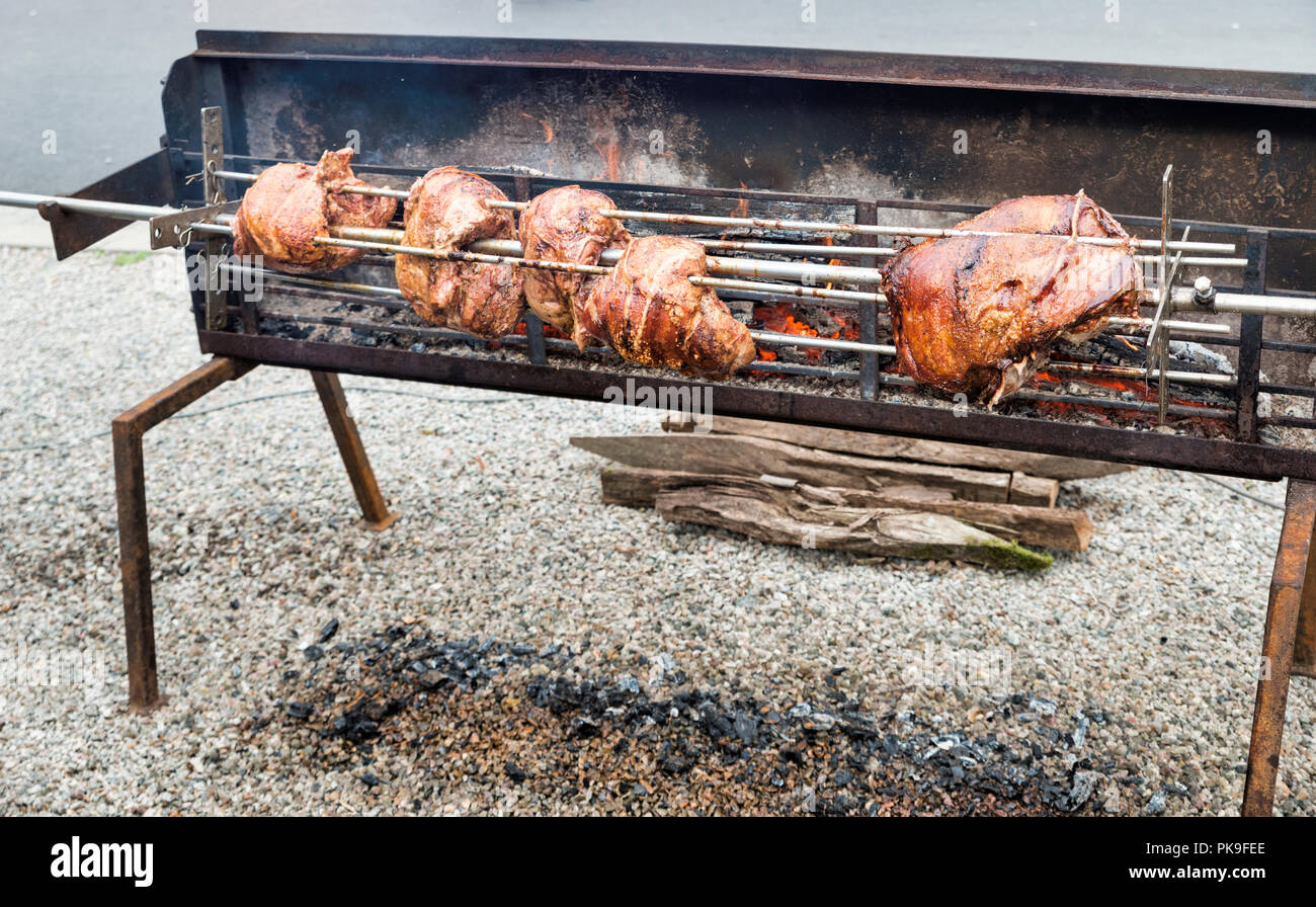 meat on the grill or spit on the street during an event Stock Photo - Alamy