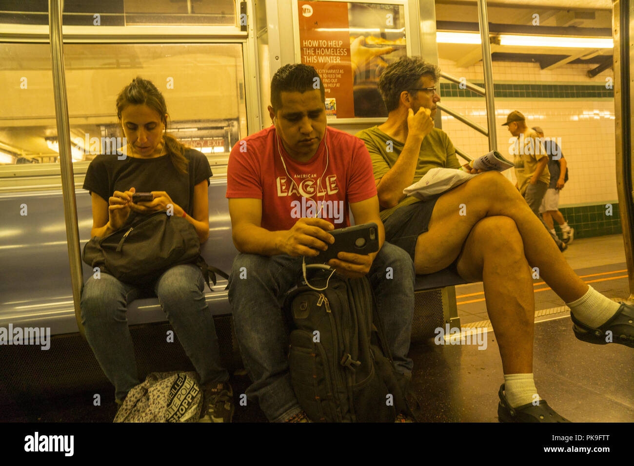 People constantly use their phones while they ride the New York CIty ...
