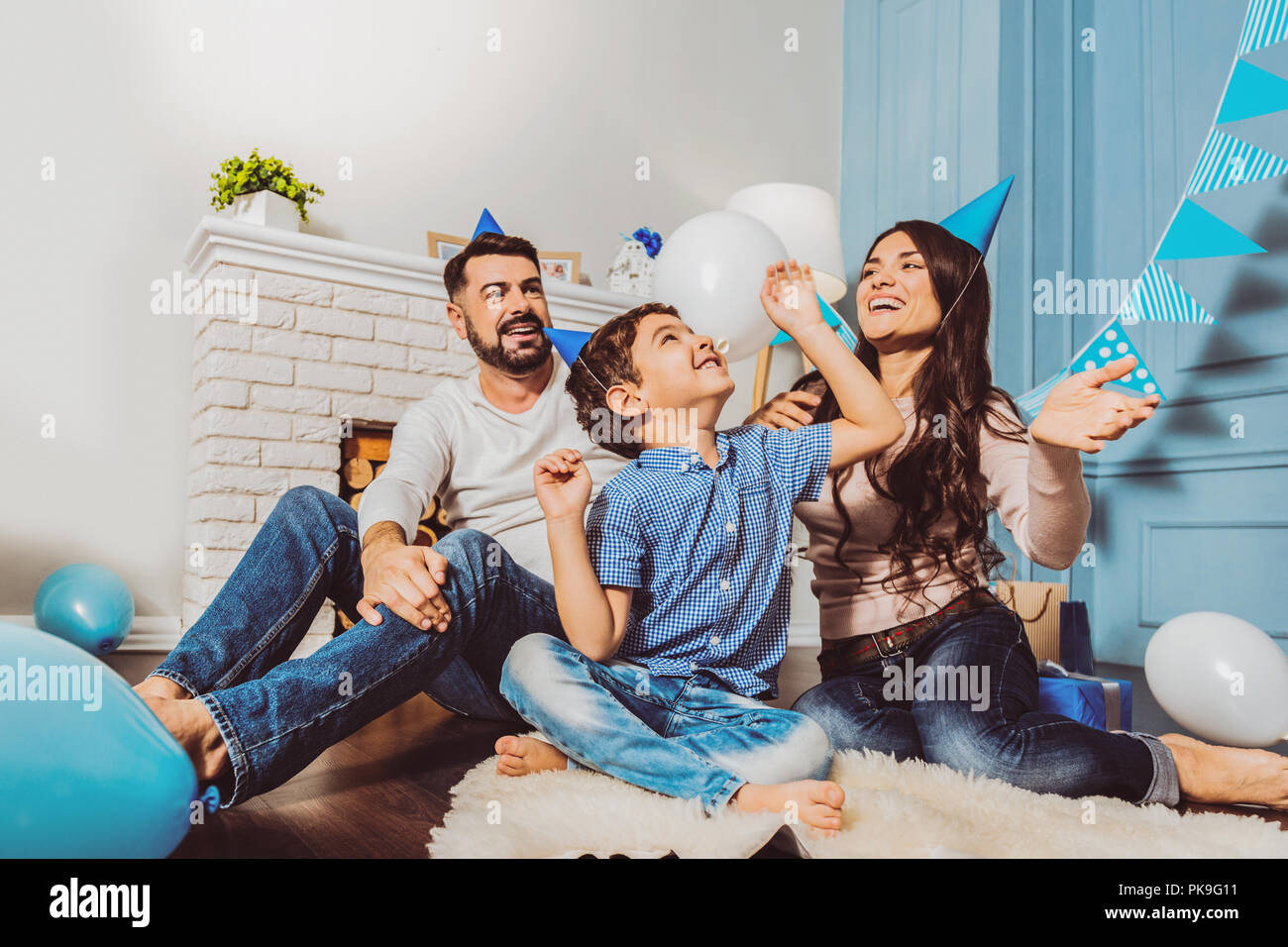 Cheerful sweet family spending birthday party Stock Photo - Alamy