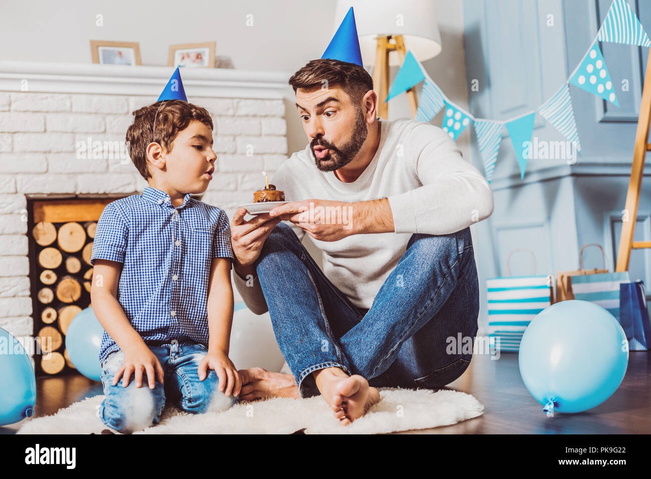 Happy positive man and boy involving in party Stock Photo - Alamy