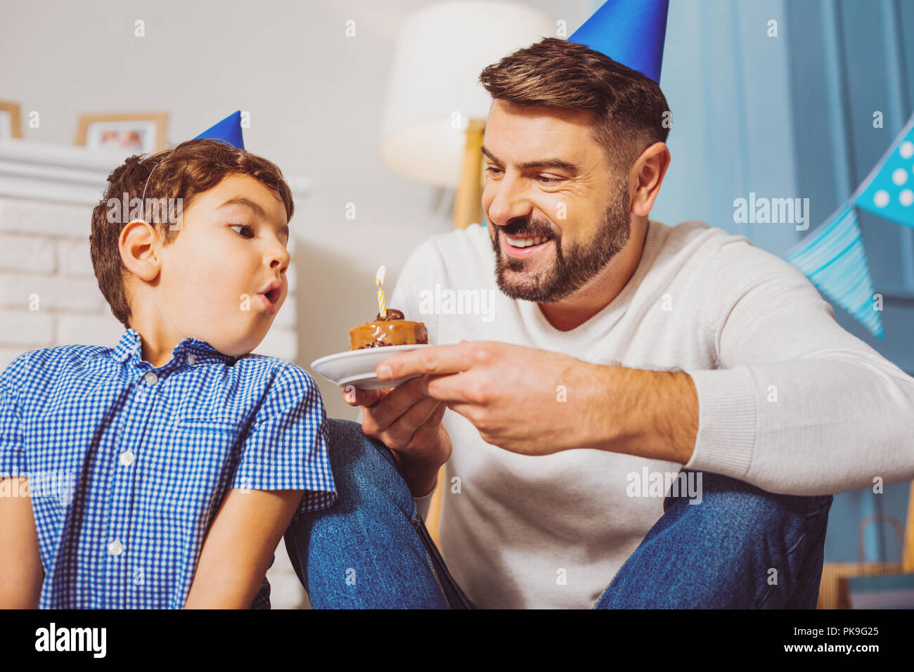 Optimistic attractive man and boy celebrating holiday Stock Photo - Alamy