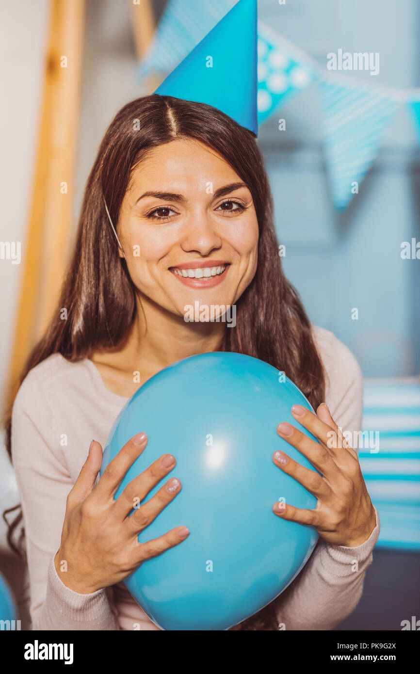 Beautiful exuberant woman hugging balloon Stock Photo - Alamy