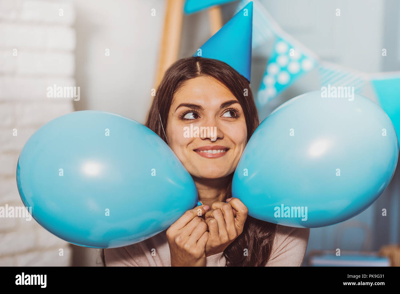 Pretty jolly woman dreaming about birthday party Stock Photo - Alamy